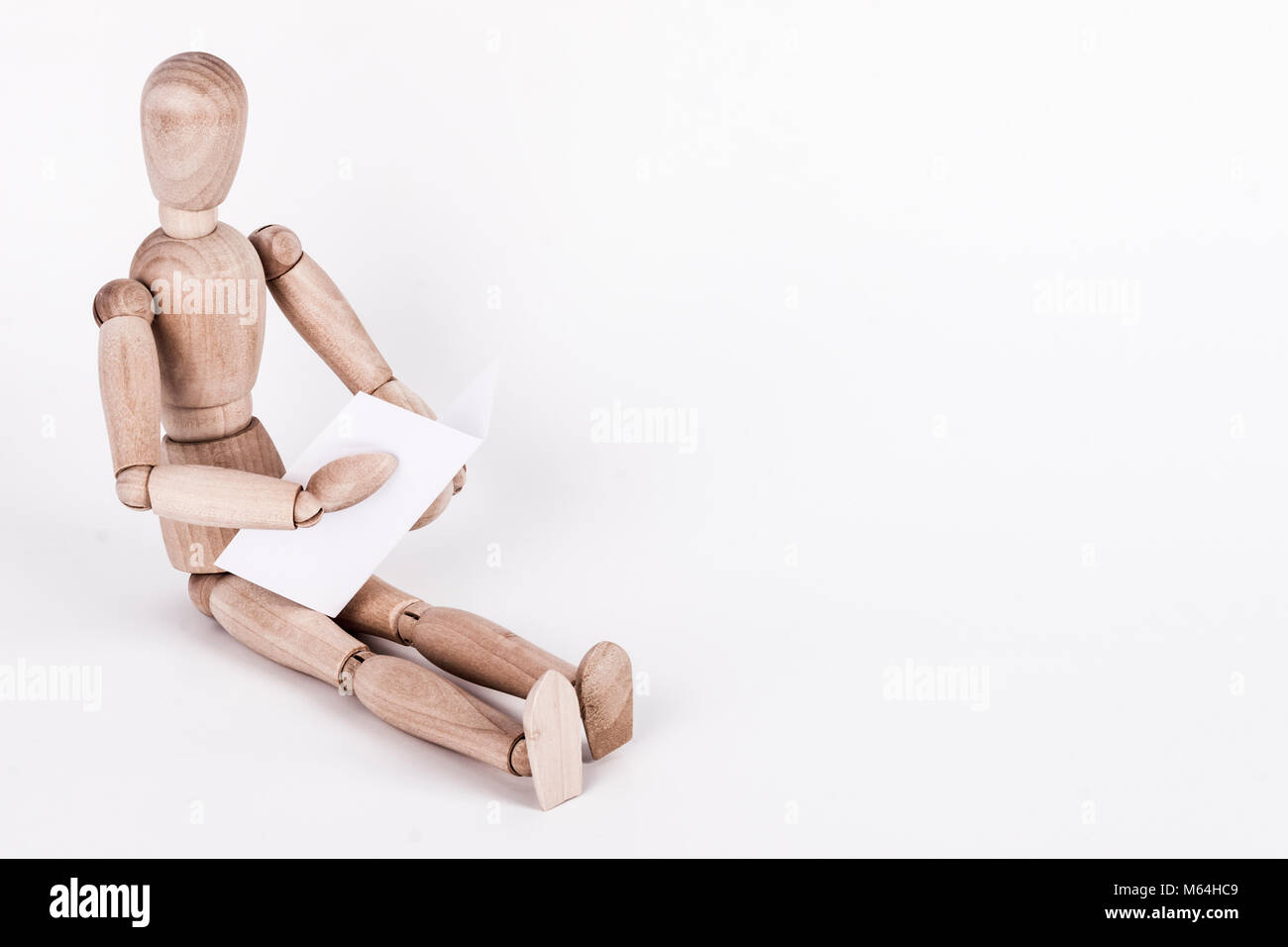 Puppet is sitting and reading Stock Photo - Alamy
