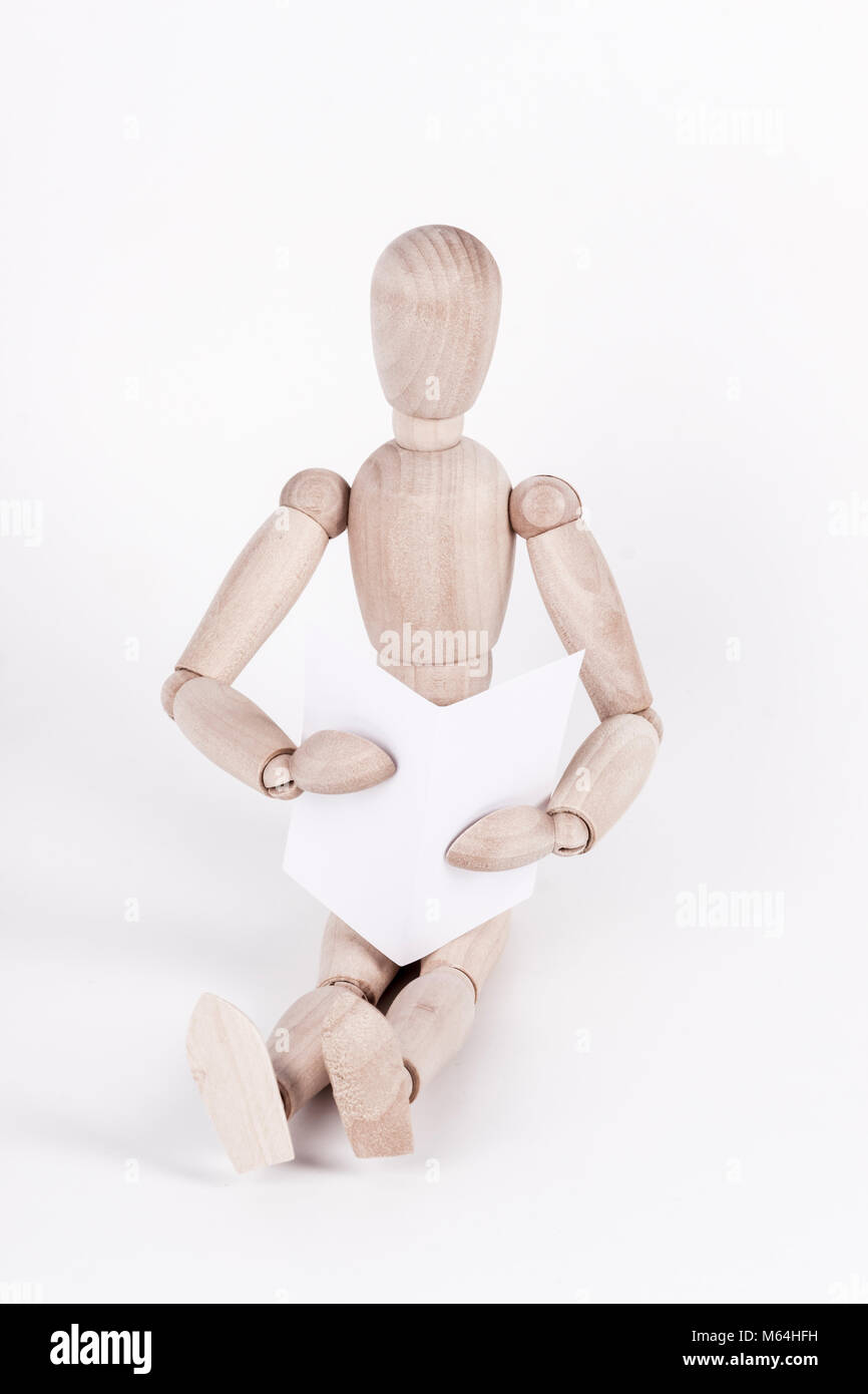 Puppet is sitting and reading Stock Photo - Alamy