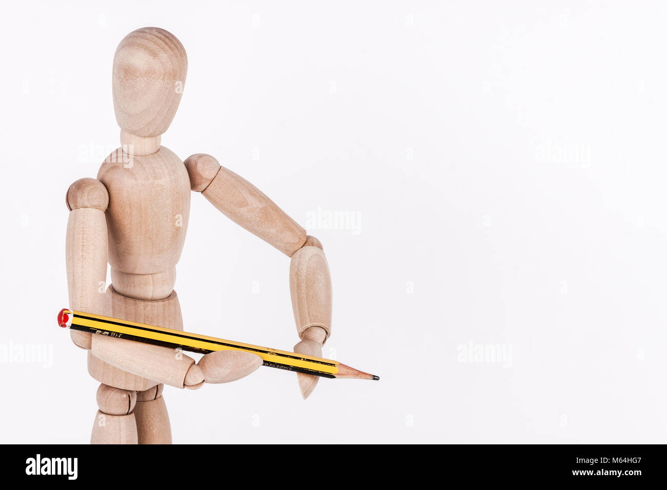 Puppet holding a pencil Stock Photo - Alamy