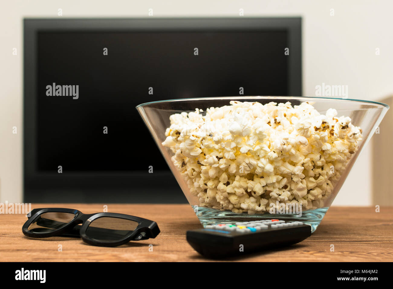 watching tv concept. Ready to have fun 3d glasses and sweet caramel ...
