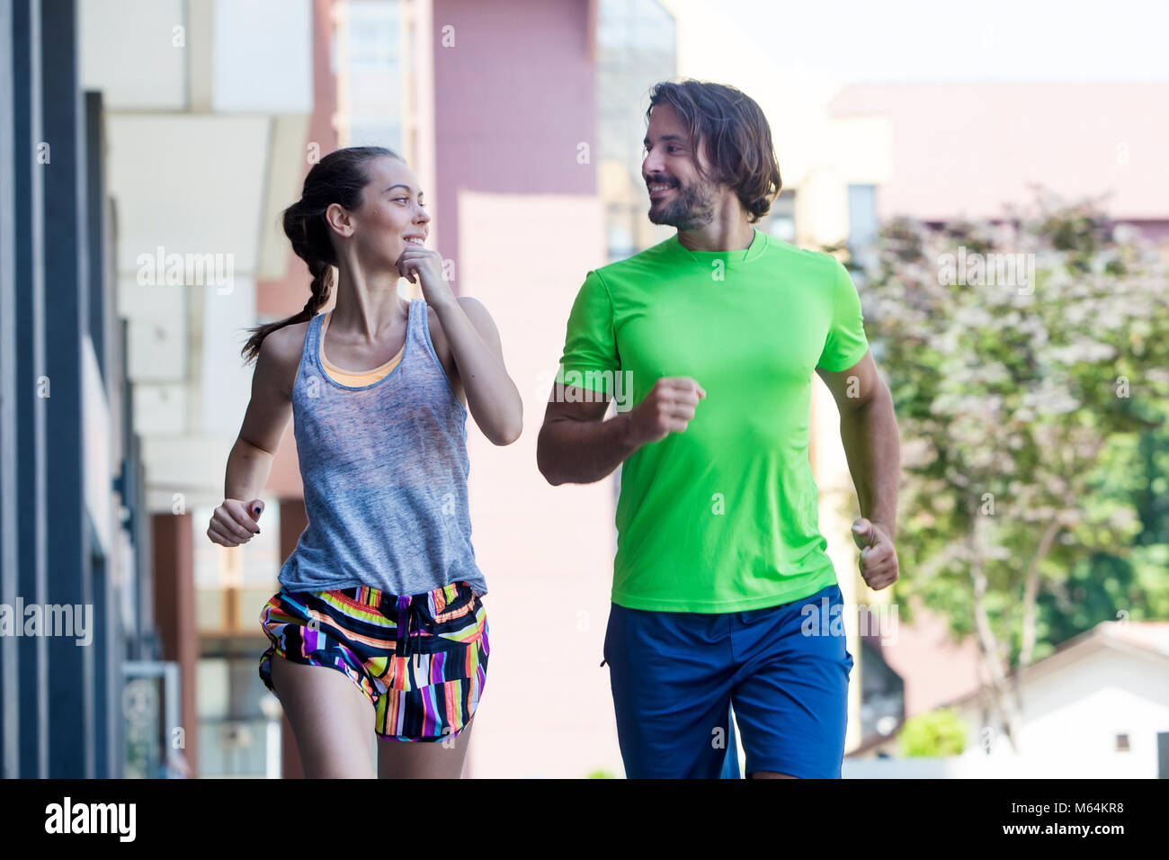 Couple running in urban enviroment at hot summer day Stock Photo - Alamy