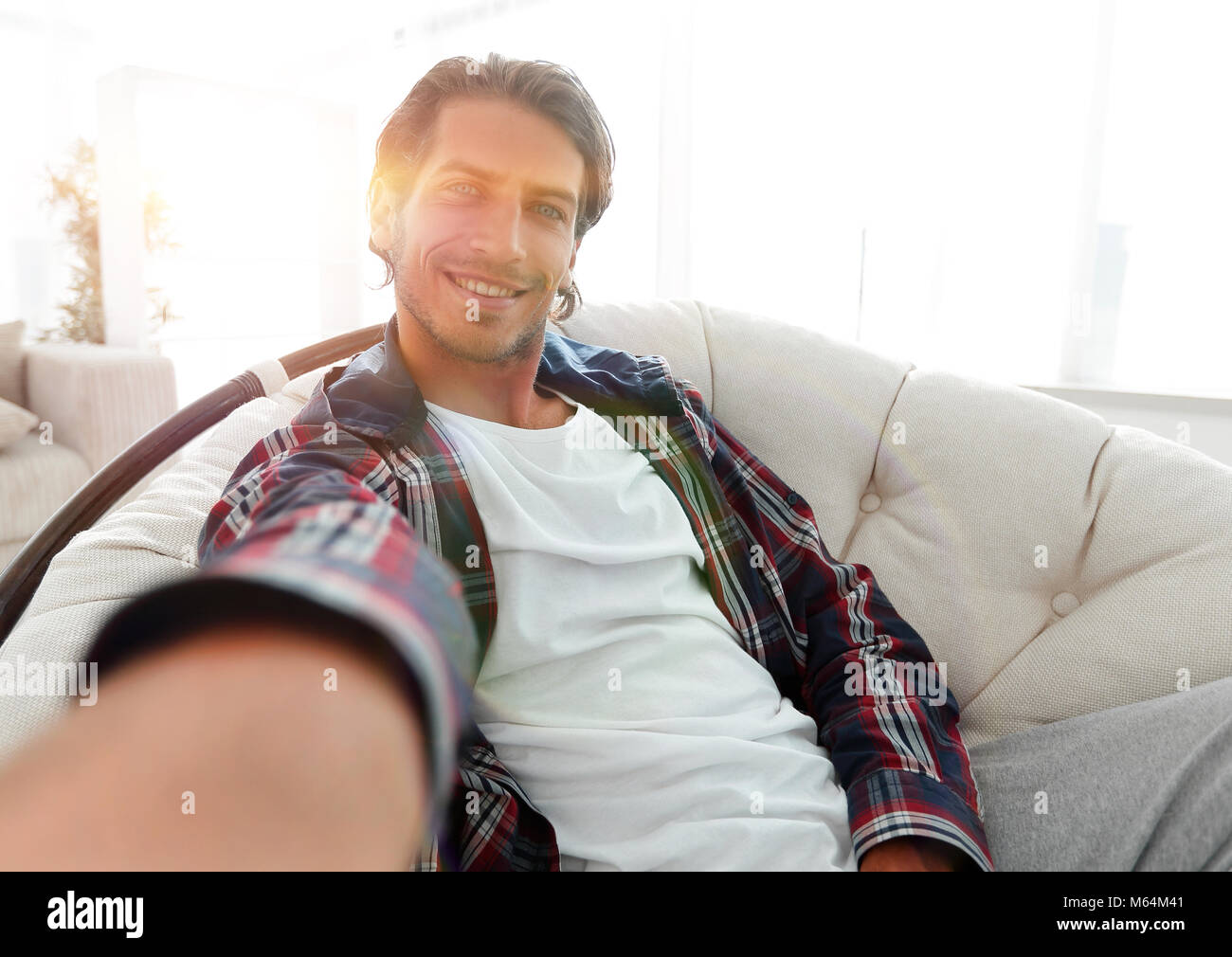 confident guy sitting in a chair and holding out his hand Stock Photo ...