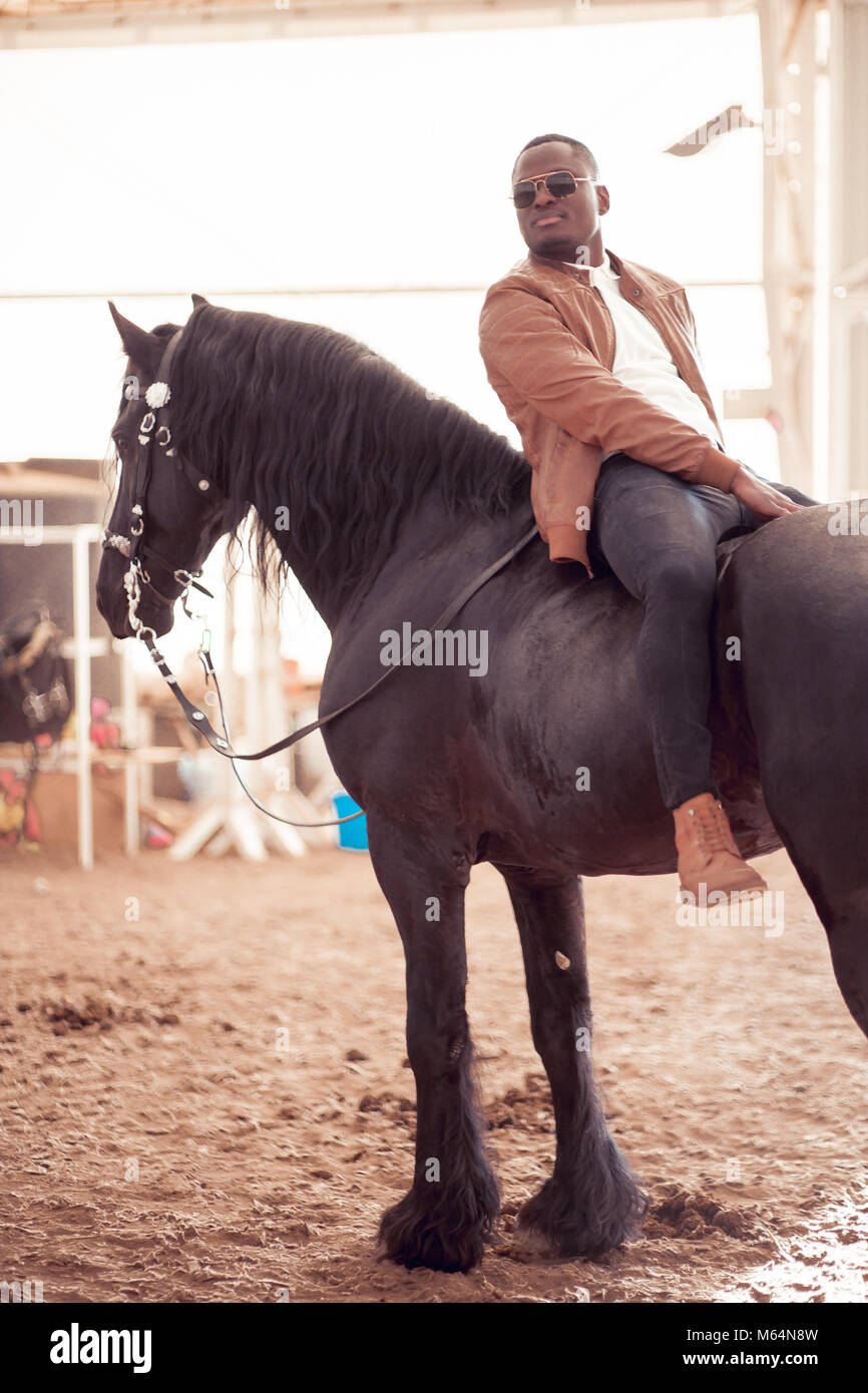 man riding brown horse on countryside Stock Photo - Alamy