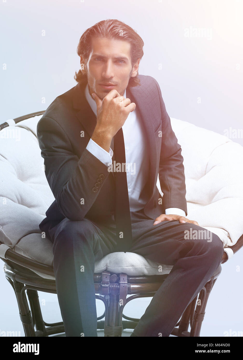 confident businessman sitting in chair Stock Photo - Alamy