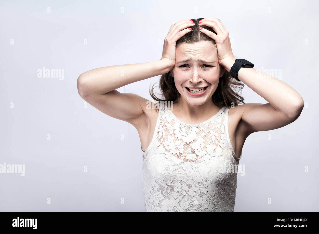 Portrait of beautiful woman with freckles and white dress and smart ...