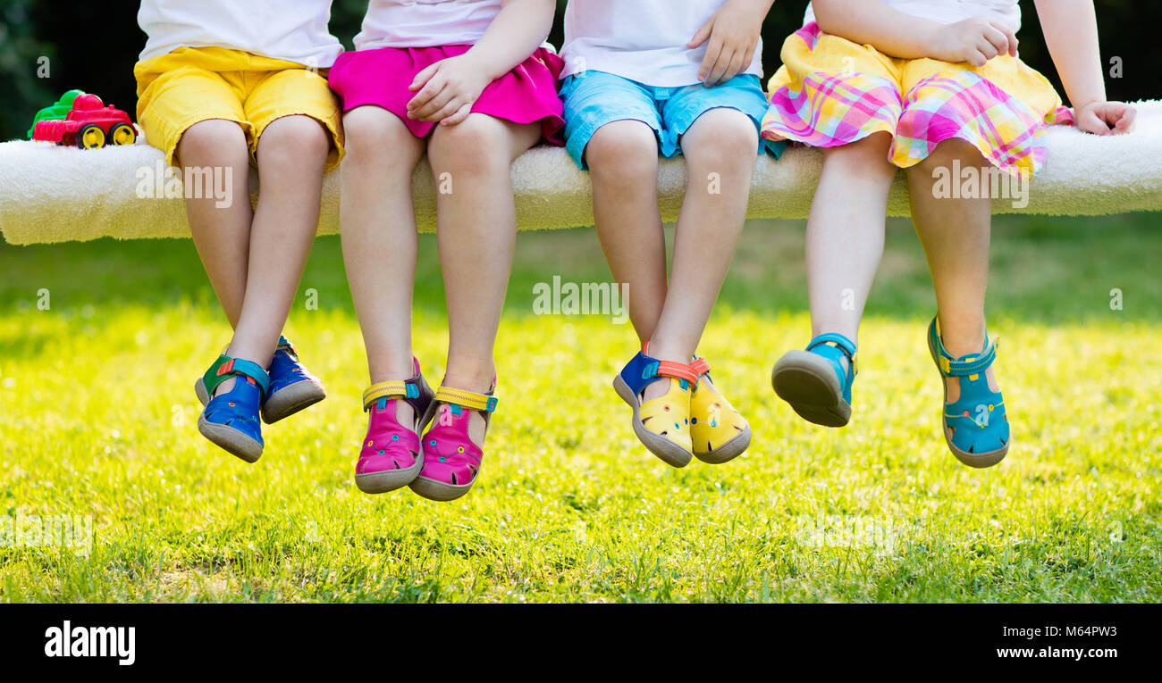 Footwear for children. Group of preschool kids wearing colorful leather ...
