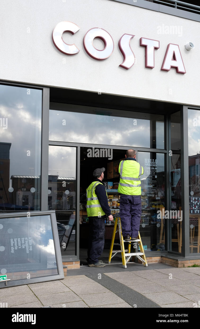 February 2018 - two men repairing the doors to a Costa coffee shop on ...