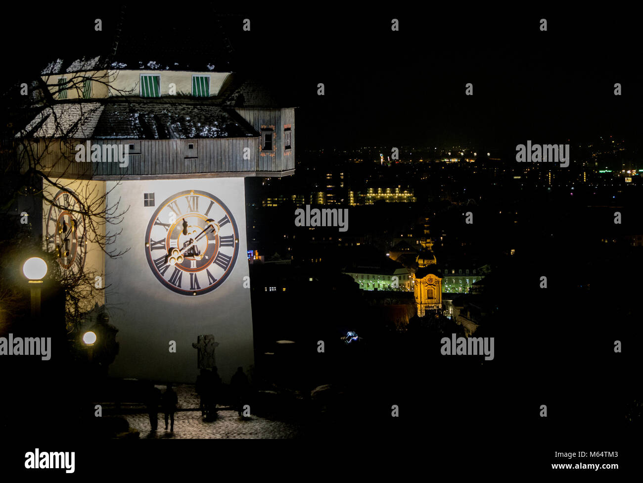 The clock tower of Graz, the town's famous symbol, illuminated at night ...