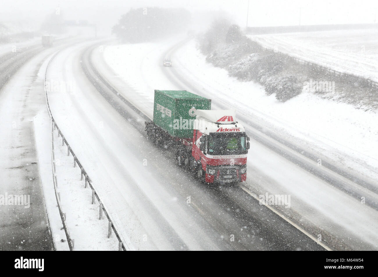 A lorry makes its way along the M9 near Falkirk during a snow blizzard ...