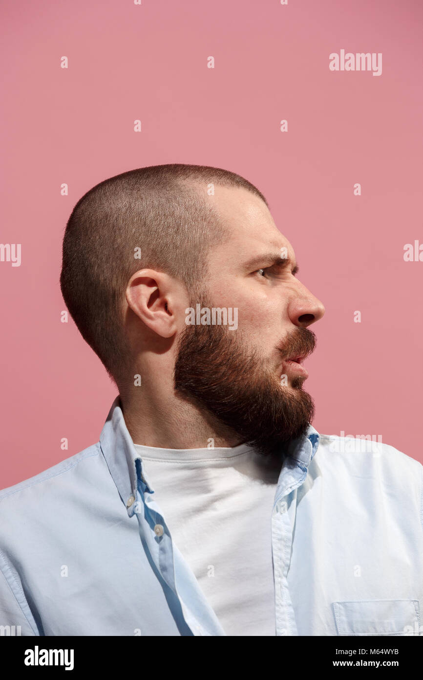 Isolated on pink young casual man disgusting at studio Stock Photo - Alamy