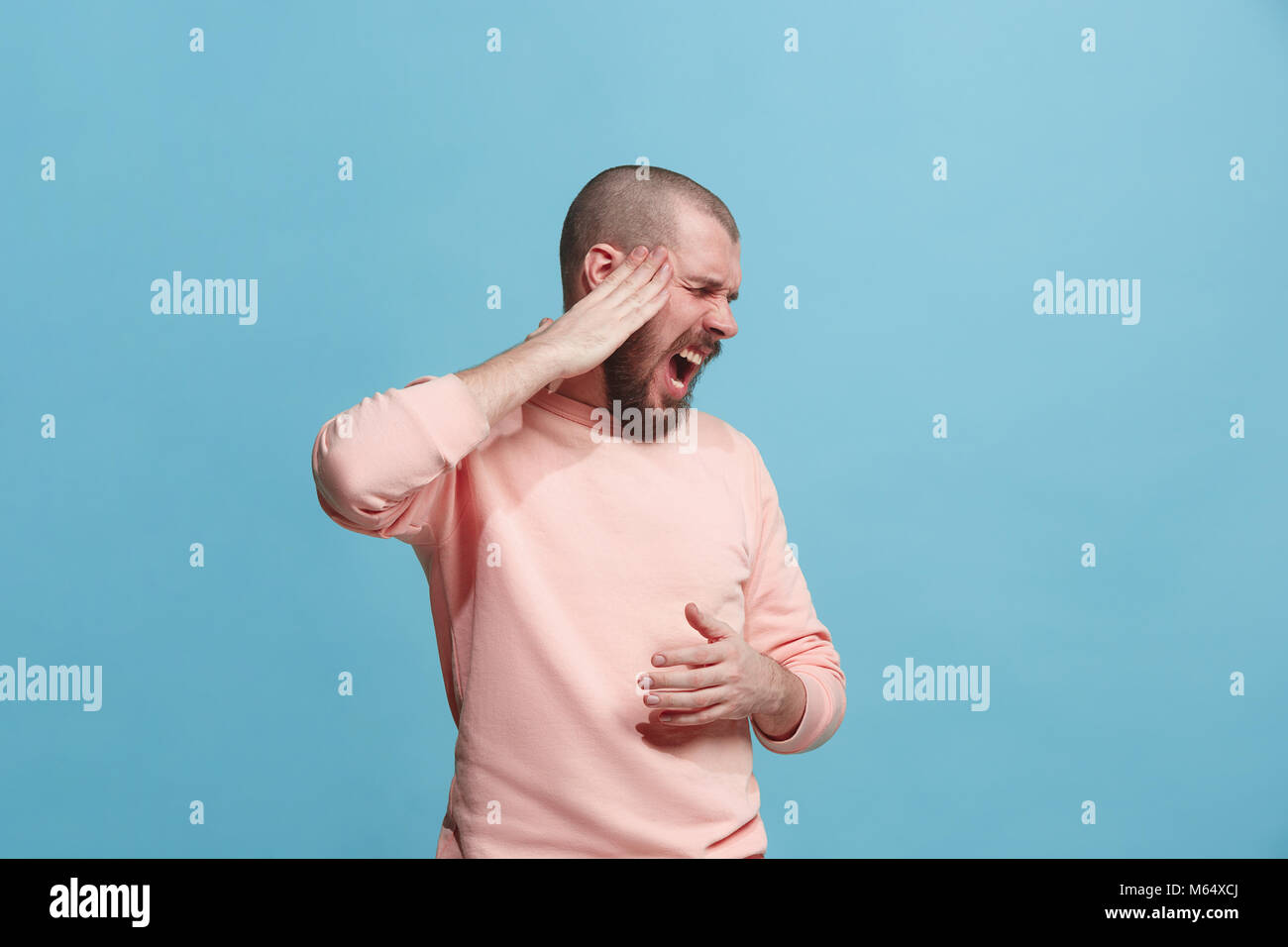 Man having headache. Isolated over blue background Stock Photo - Alamy