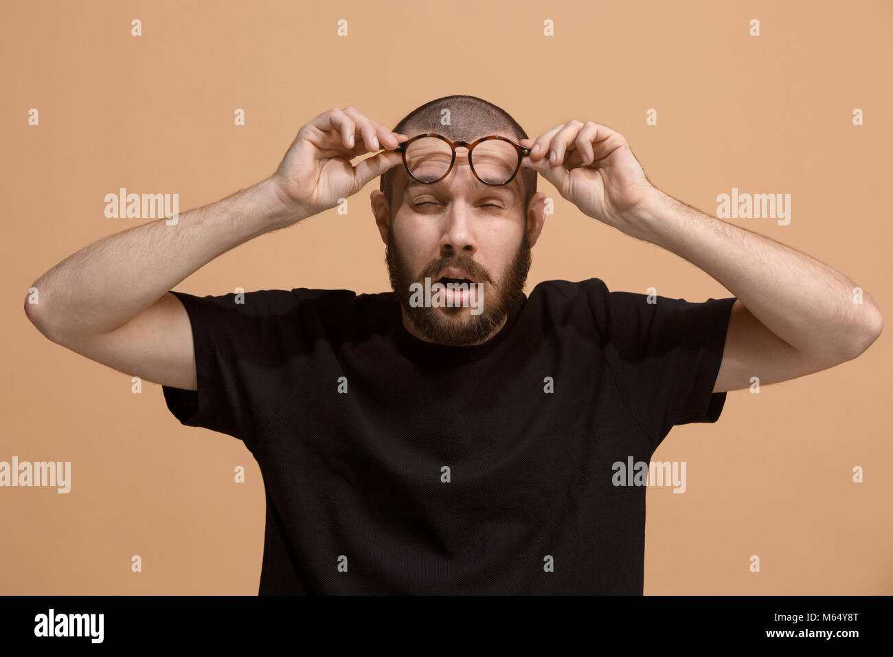 Beautiful bored man bored isolated on pastel background Stock Photo - Alamy