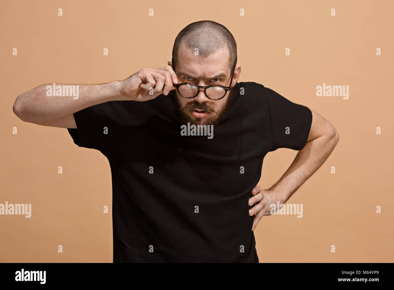 The young emotional angry man on pastel studio background Stock Photo ...
