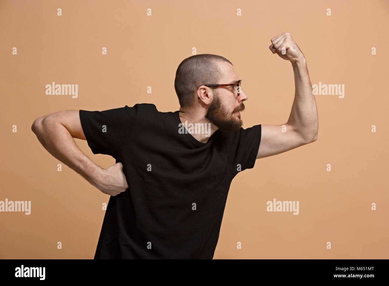 The young emotional angry man on pastel studio background Stock Photo ...