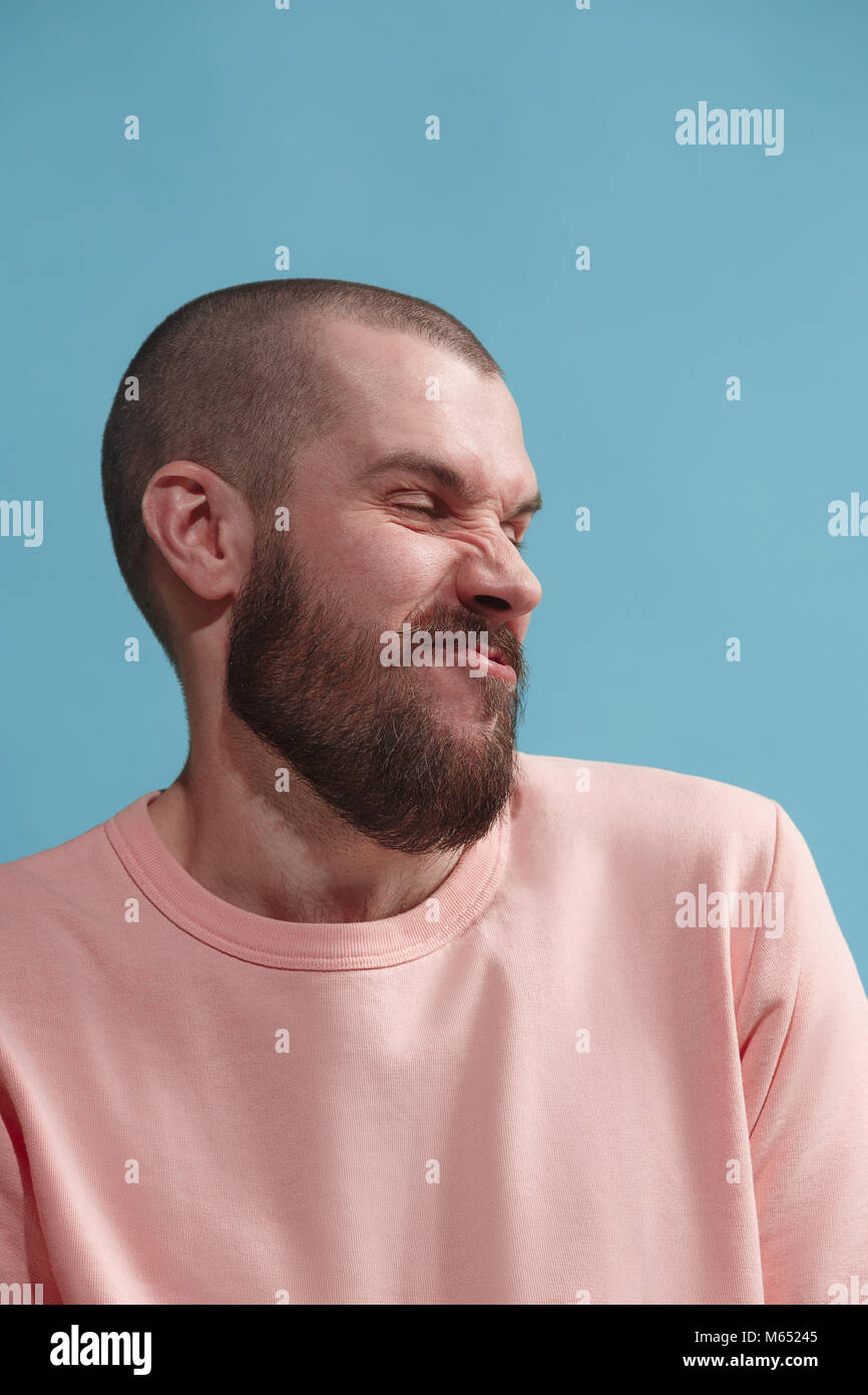 Young man with disgusted expression repulsing something, isolated on ...