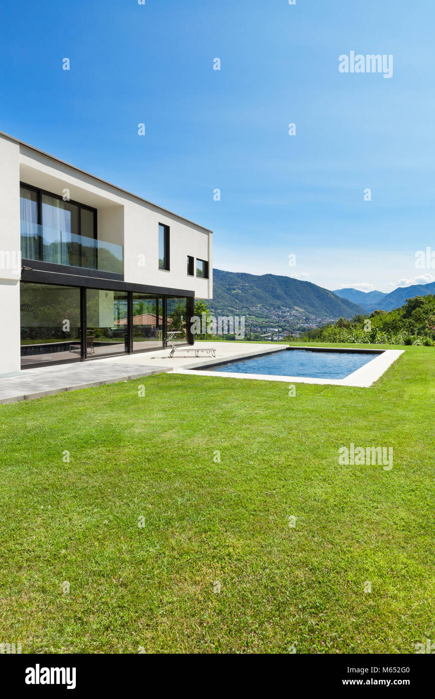 Modern villa with pool, view from the garden Stock Photo - Alamy