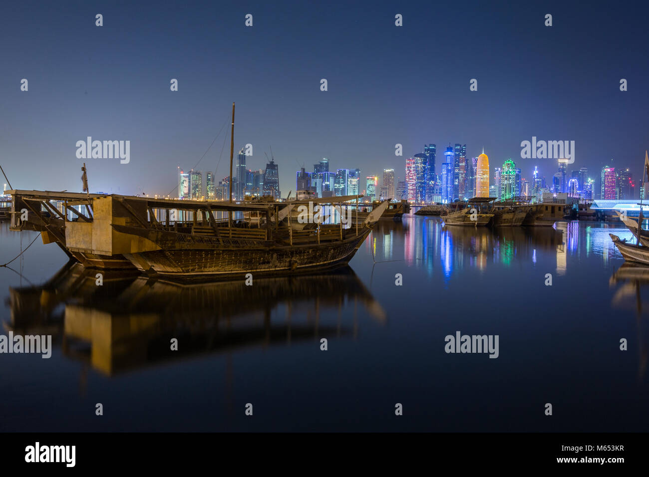 A view of Doha skyline at night with barges in the foreground Stock ...