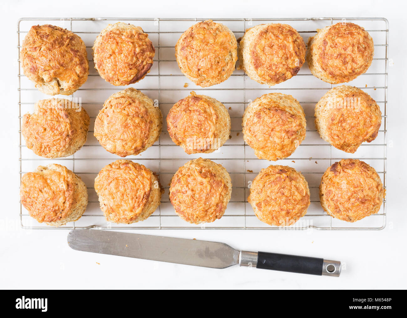 Freshly baked cheese scones cooling on a wire tray Stock Photo - Alamy