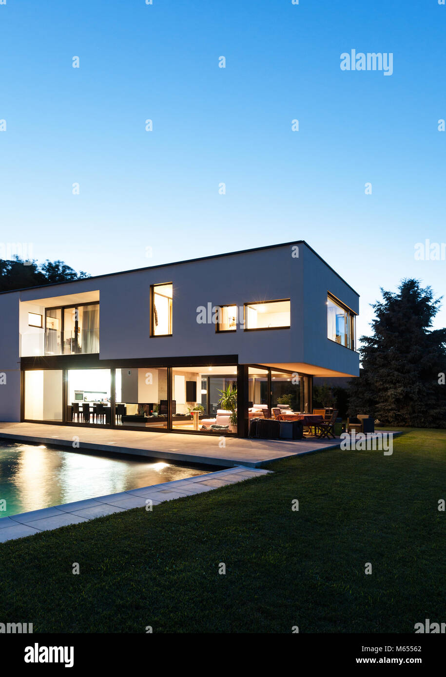 Modern villa with pool, view from garden, night scene Stock Photo - Alamy
