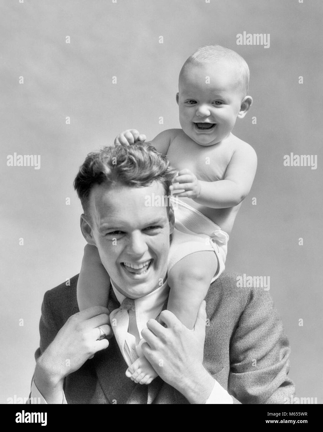 Kid on his father shoulders Black and White Stock Photos & Images - Alamy