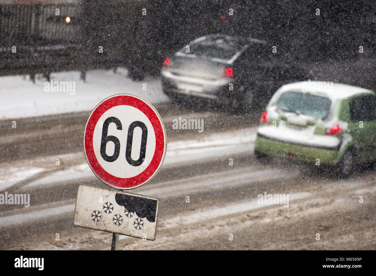 Winter traffic jam during snowstorm with poor visibility. Snow sign and ...