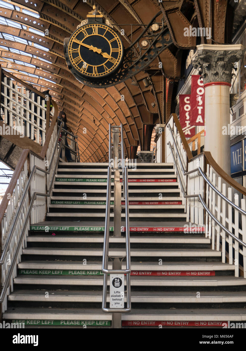 Stairs to pedestrian bridge across rail tracks to access platforms at ...