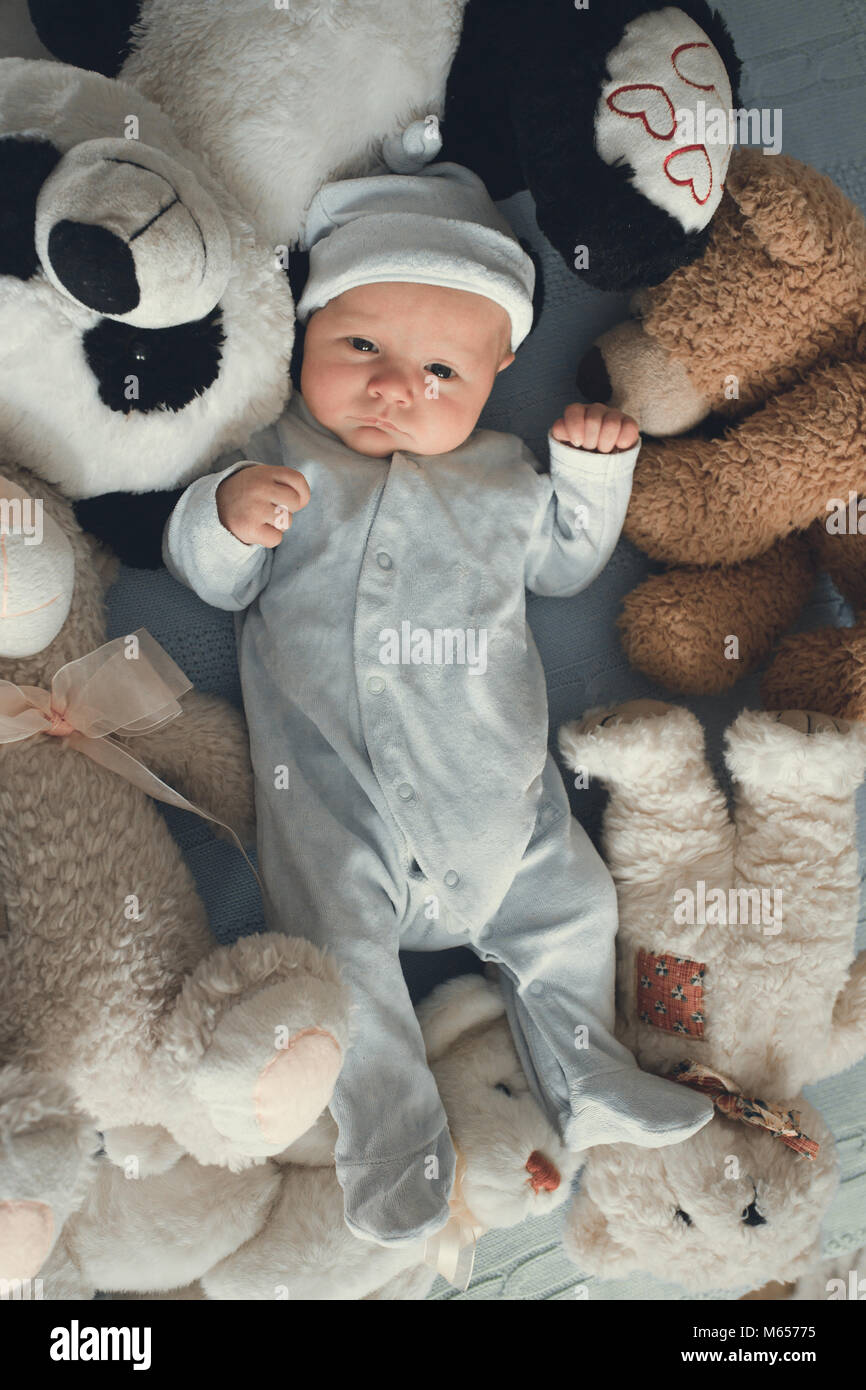 newborn baby laying with five teddy bears on blanket Stock Photo - Alamy