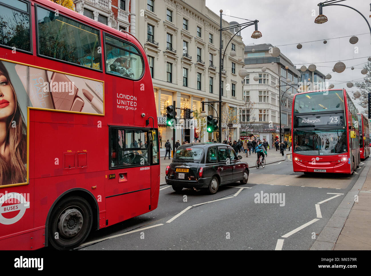 A Black Taxi and two London buses on Oxford St , London Stock Photo - Alamy