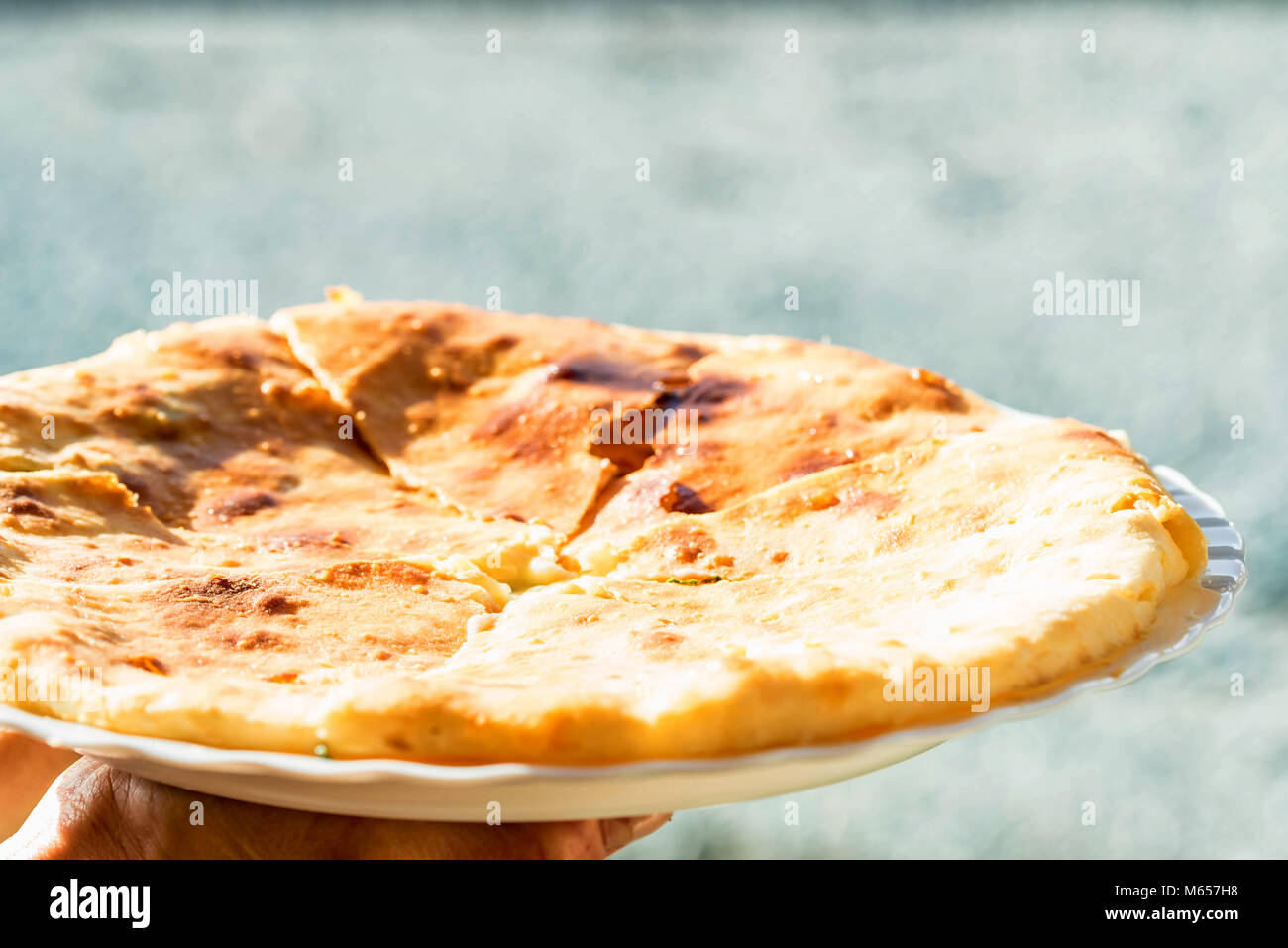 Caucasian khychin bread pie with cheese close Stock Photo - Alamy