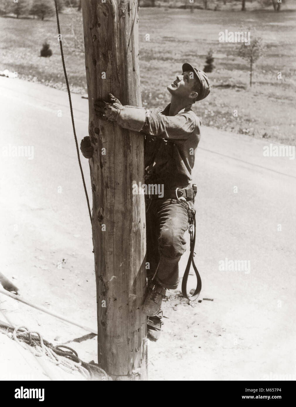 Worker climbing utility pole hi-res stock photography and images - Alamy