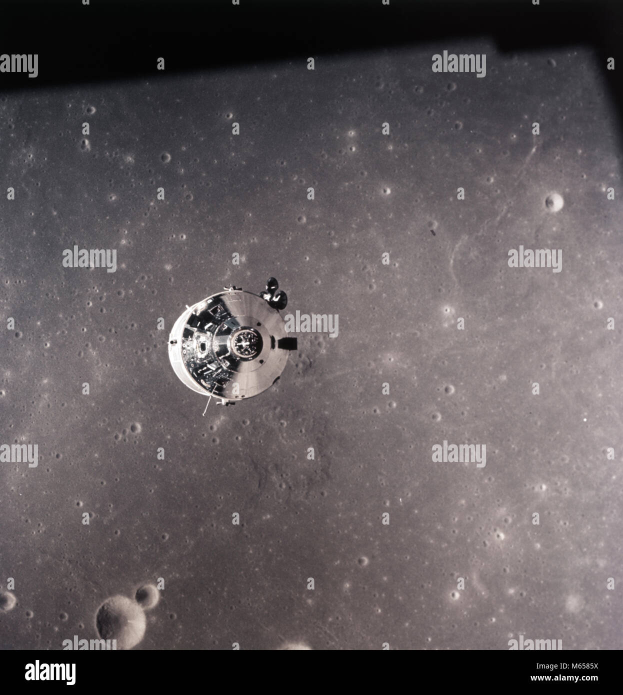 1960s JULY 1969 APOLLO 11 COMMAND MODULE OVER THE SURFACE OF THE MOON ...