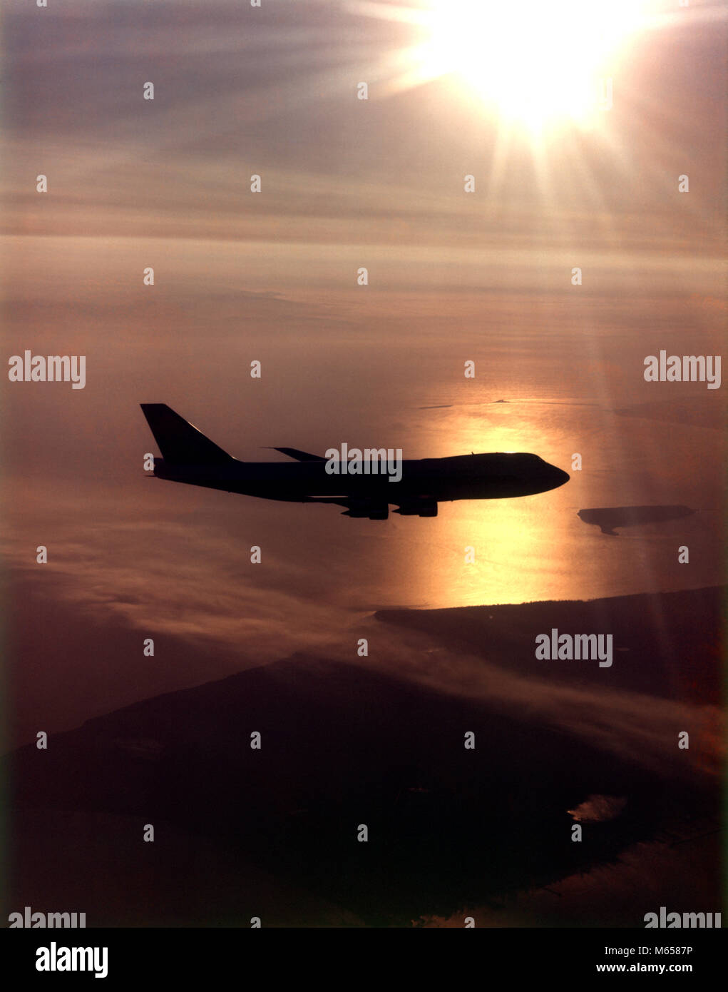 1970s SILHOUETTE BOEING 747 AIRPLANE FLYING IN SUNSET SKY COMMERCIAL ...