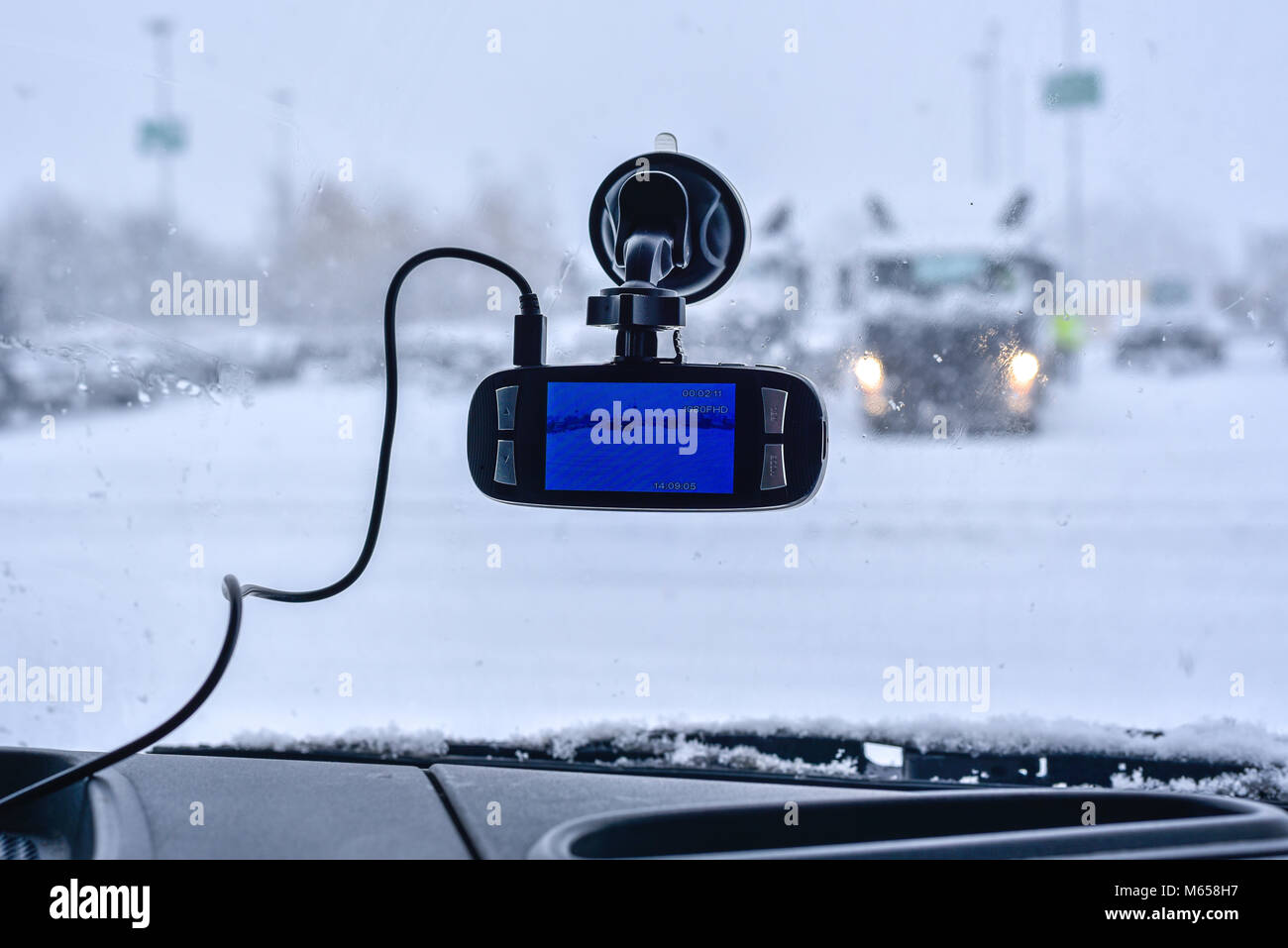 A car dash cam mounted on the front windshield recording the traffic ...