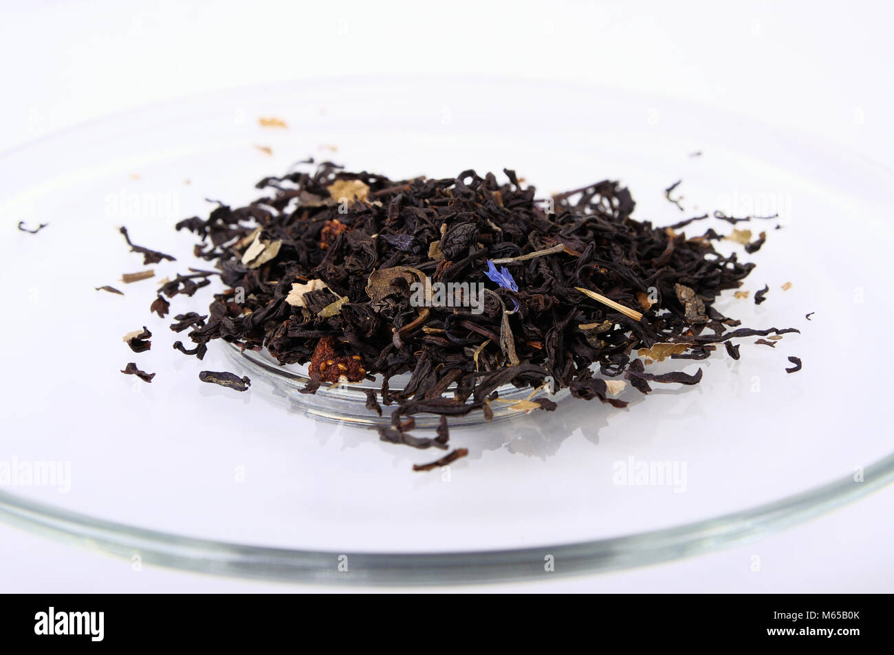 A pile of tea leaves on a glass saucer closeup Stock Photo - Alamy