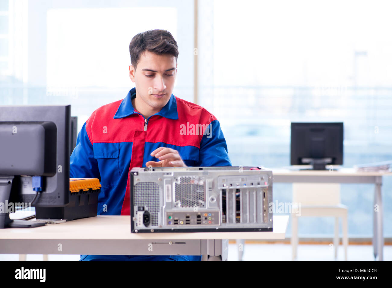Computer repairman specialist repairing computer desktop Stock Photo ...