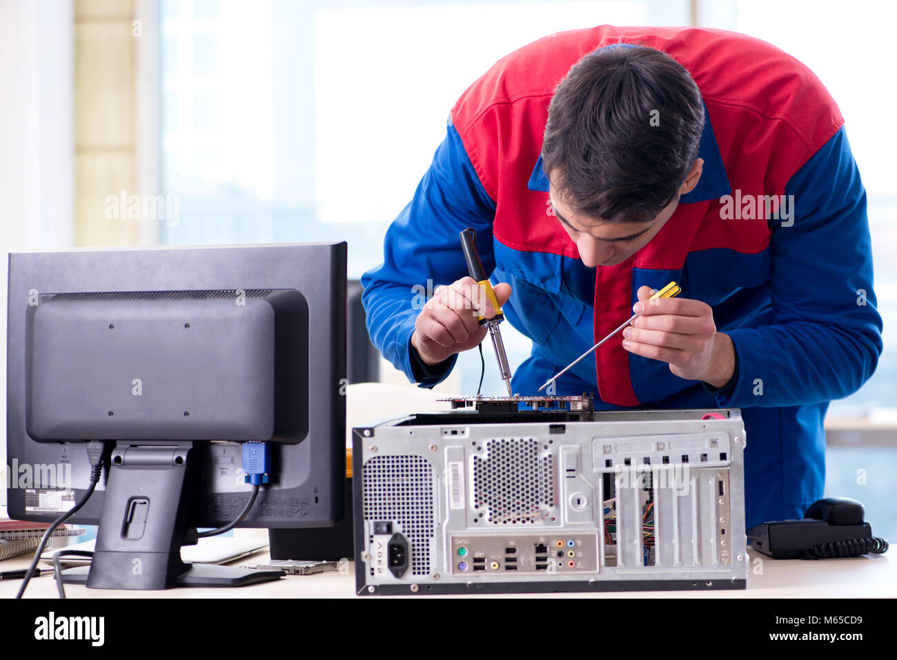 Computer repairman specialist repairing computer desktop Stock Photo ...