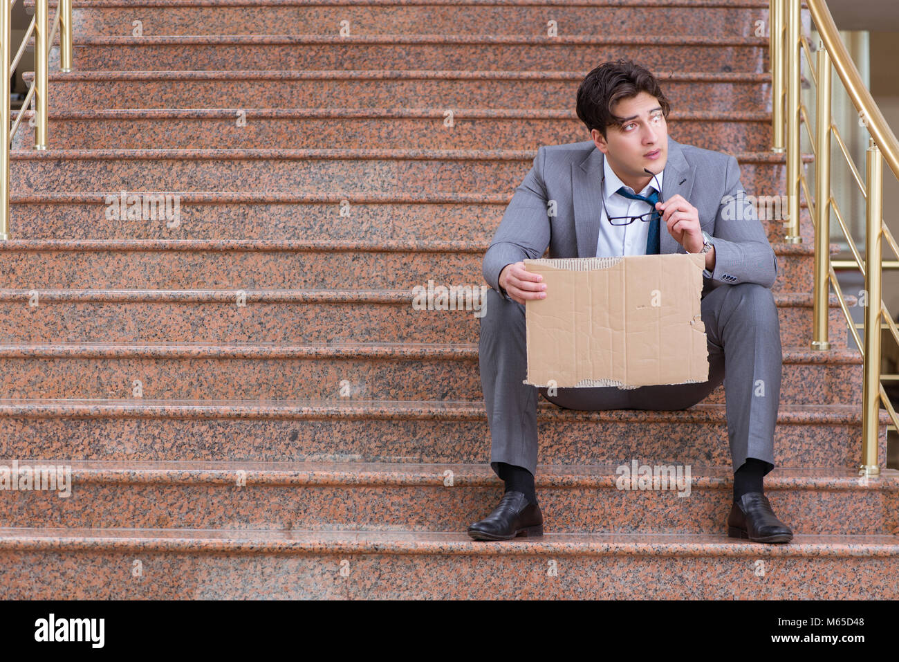 Desperate businessman begging on the street Stock Photo - Alamy
