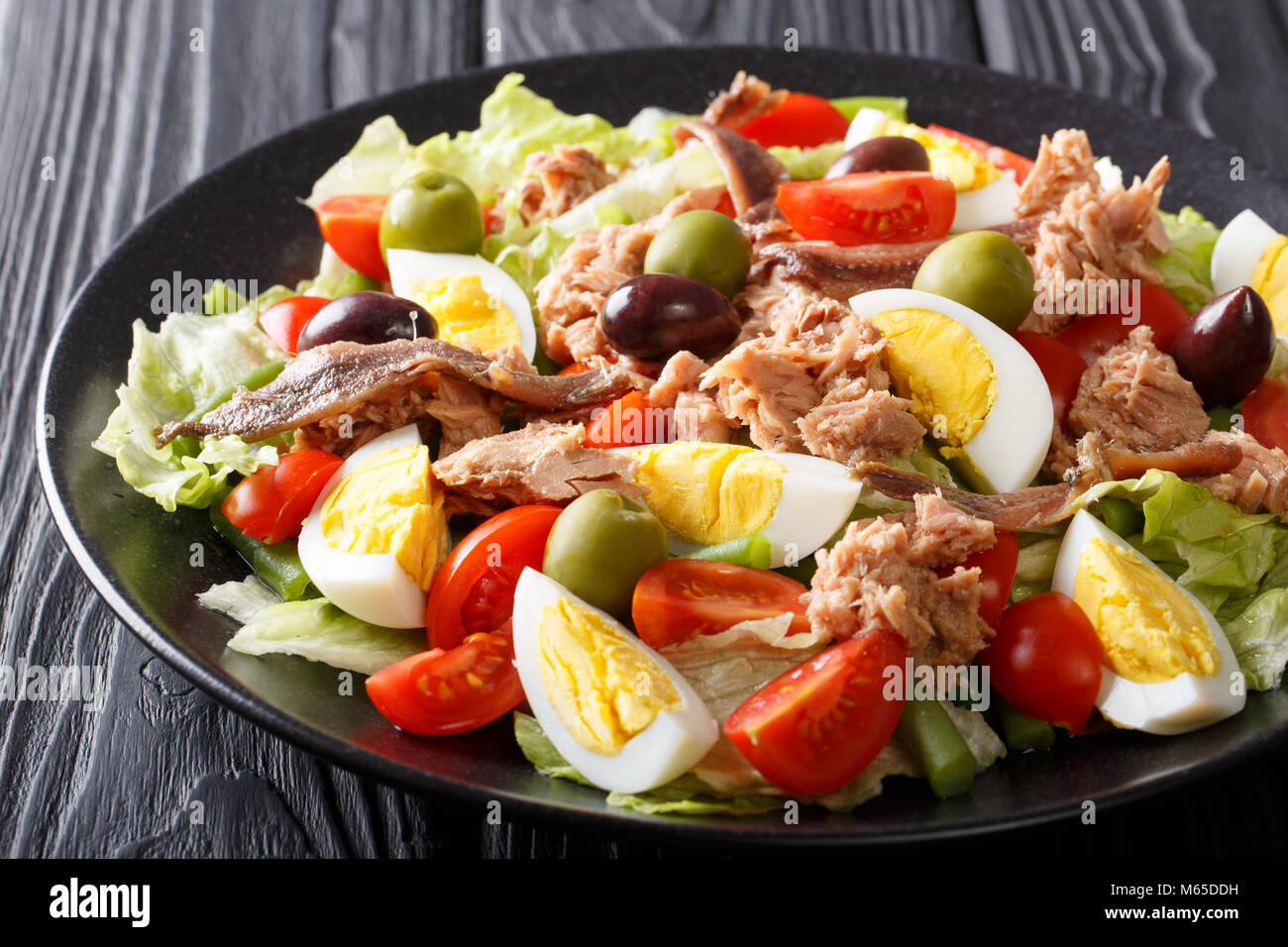 Home fish nicoise salad of tuna, anchovies, eggs and vegetables close ...