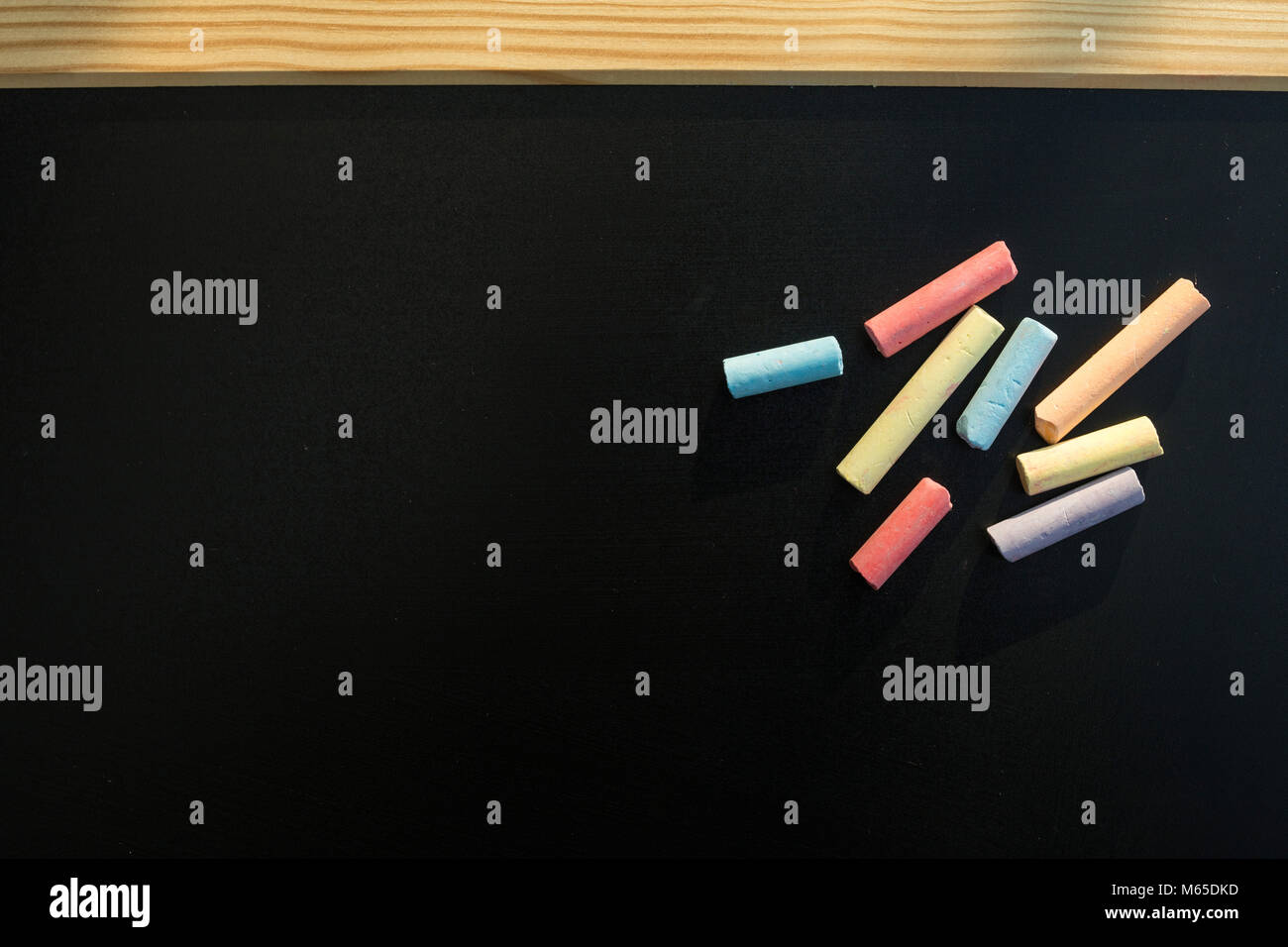 Group of multicolored chalks on black chalkboard Stock Photo - Alamy