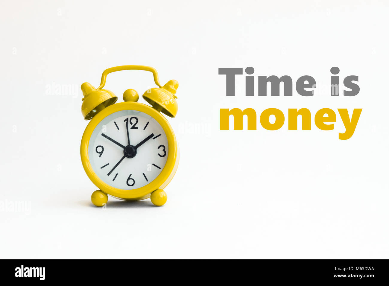 small analogue yellow golden clock in isolated white background with ...