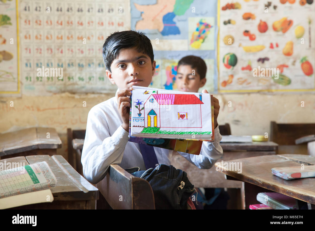 Boy showcasing house drawing, Education in Pakistani Government Schools ...
