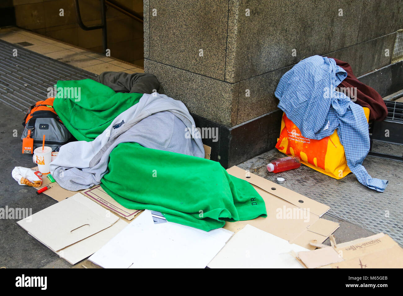 Homeless person sleeping outside Leicester Square underground station ... Homeless person sleeping outside Leicester Square underground station ...