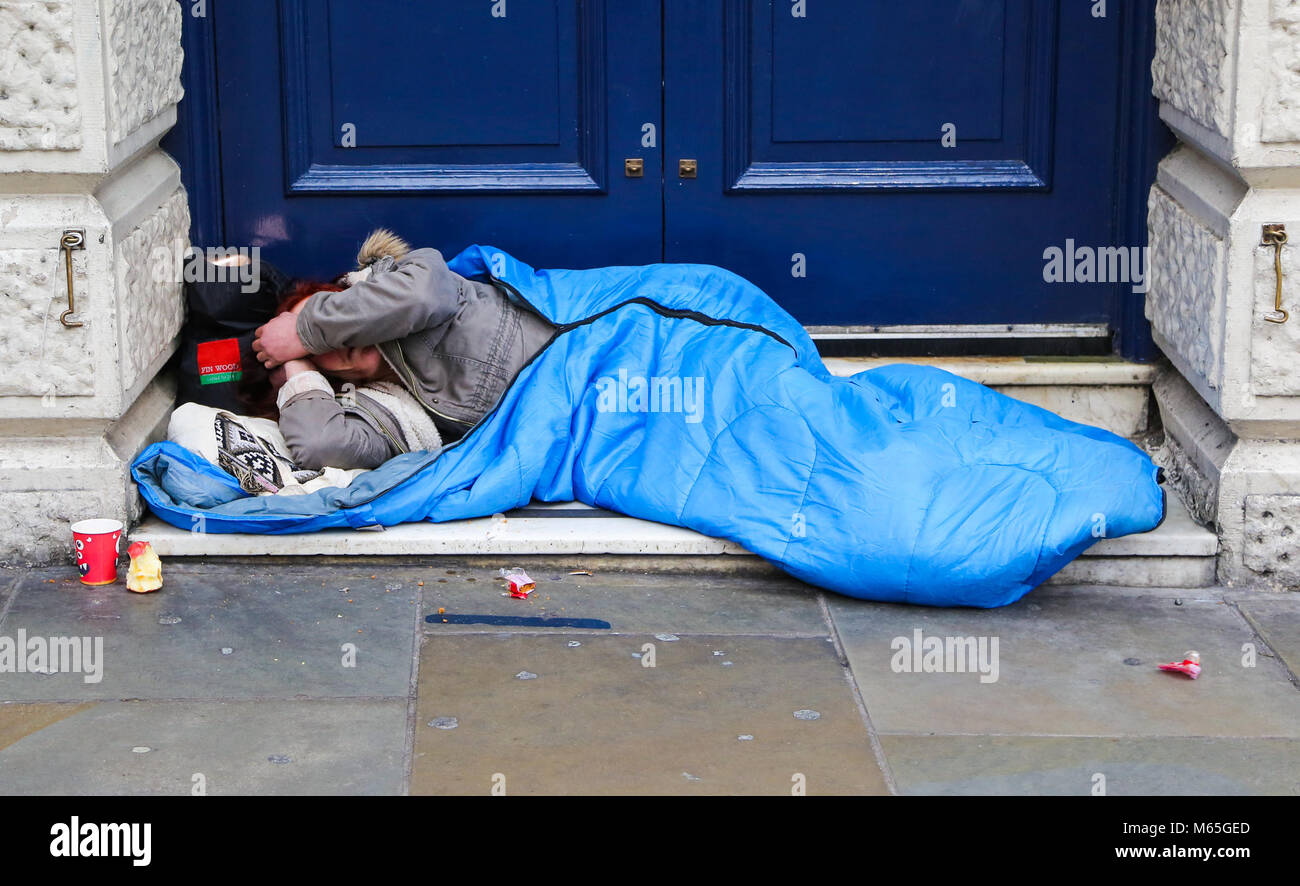 Homeless person sleeping outside Leicester Square underground station ... Homeless person sleeping outside Leicester Square underground station ...