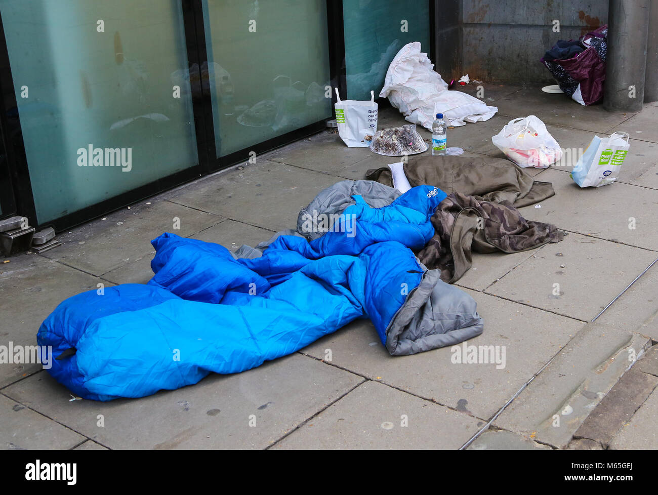 Homeless person sleeping outside Leicester Square underground station ... Homeless person sleeping outside Leicester Square underground station ...