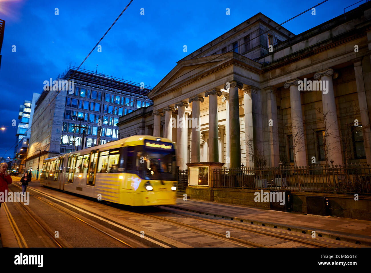 At night a Metrolink tram passing Manchester Art Gallery on Lower ...