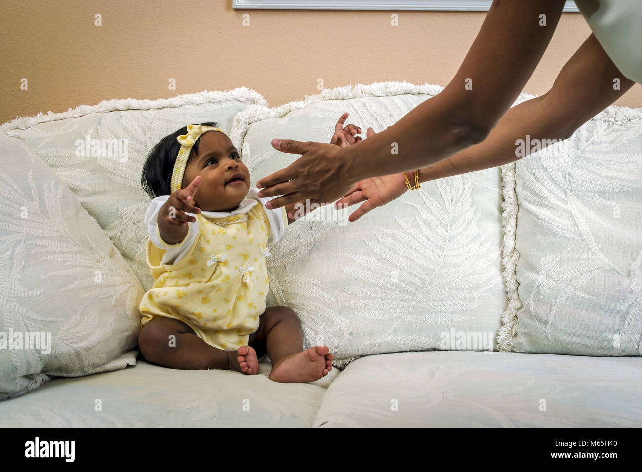 Sri Lanka American,Baby girl reaching for mothers arms © Myrleen ...