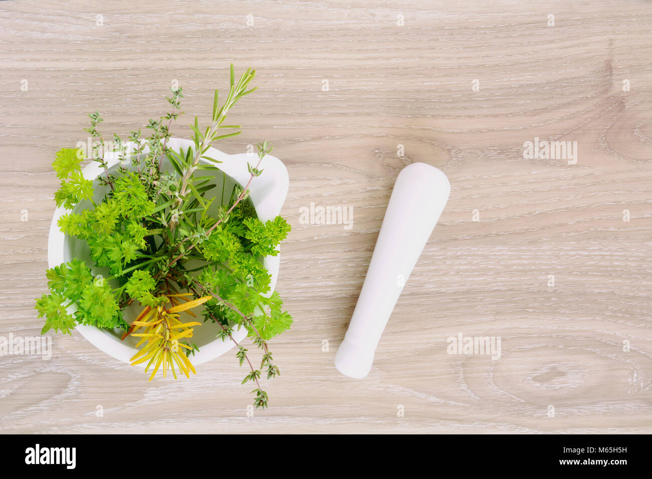 Mortar and pestle with fresh herbs in flat lay format and shot in ...