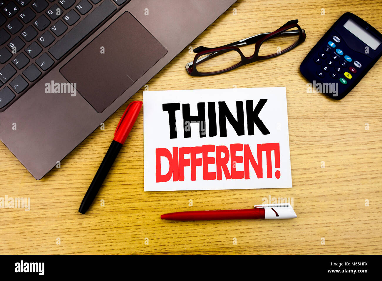 Handwritten text caption showing Think Different. Business concept ...