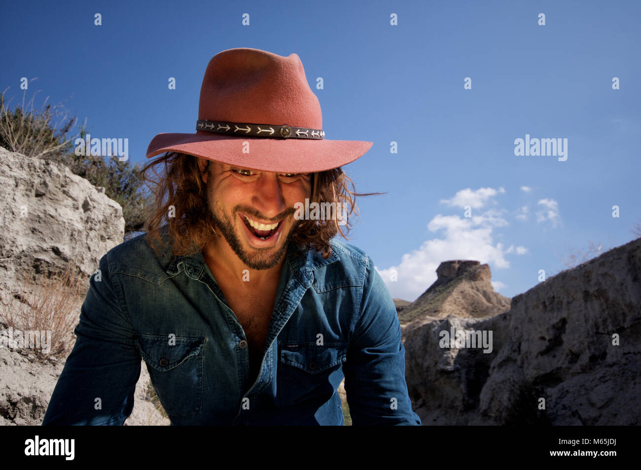 Cowboy looking happy upon finding treasure Stock Photo - Alamy