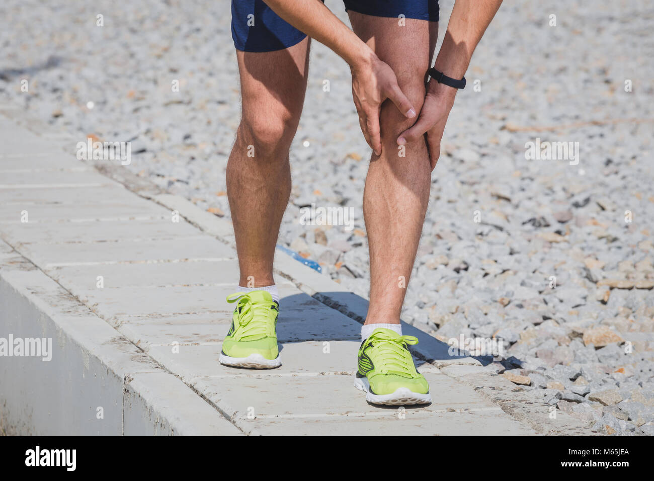 Running athlete feeling pain after having his knee injured. Accident on ...